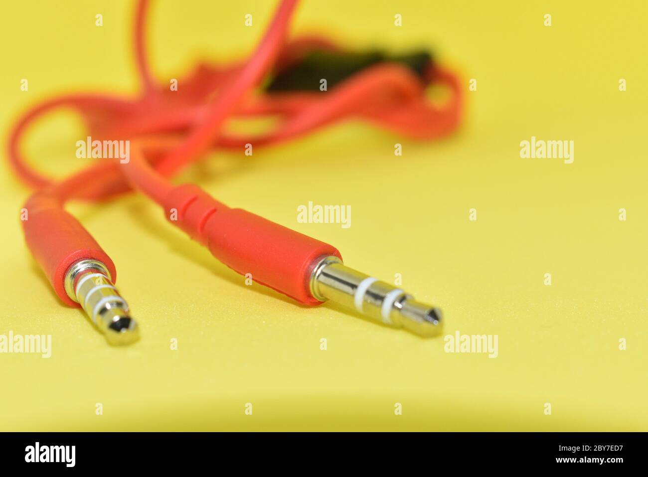 Red color cable in yellow background Stock Photo - Alamy