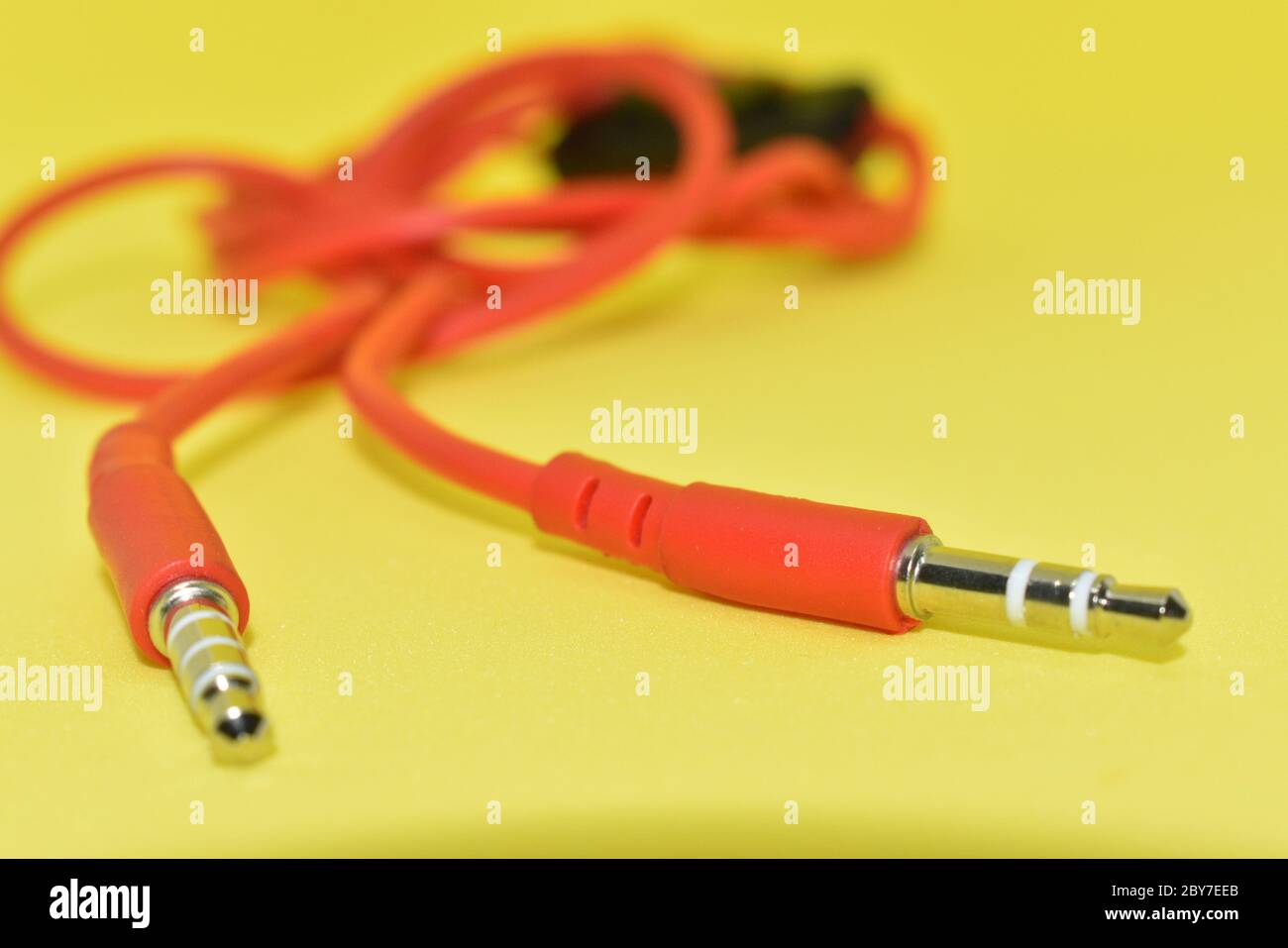 Red color cable in yellow background Stock Photo - Alamy