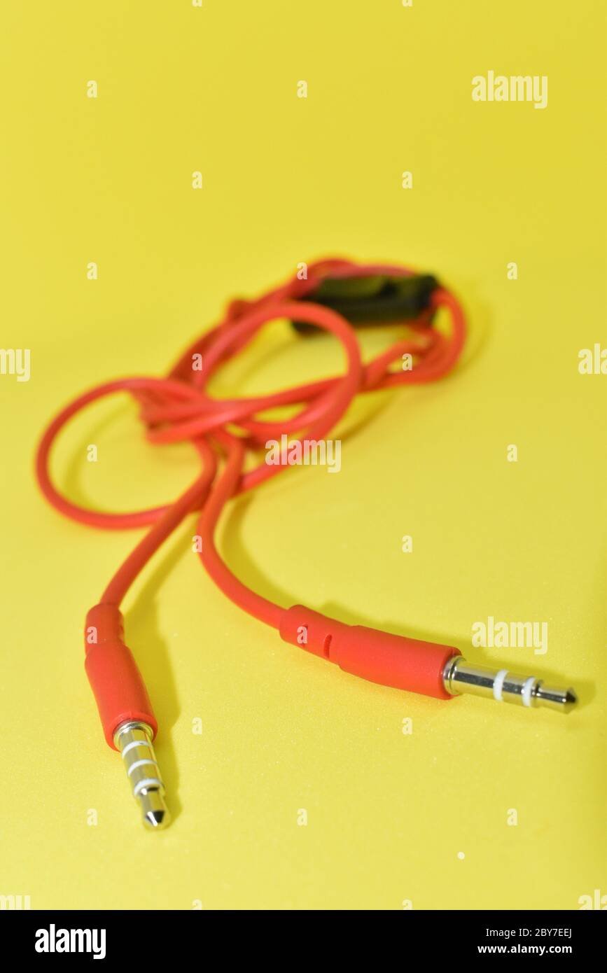Red color cable in yellow background Stock Photo - Alamy