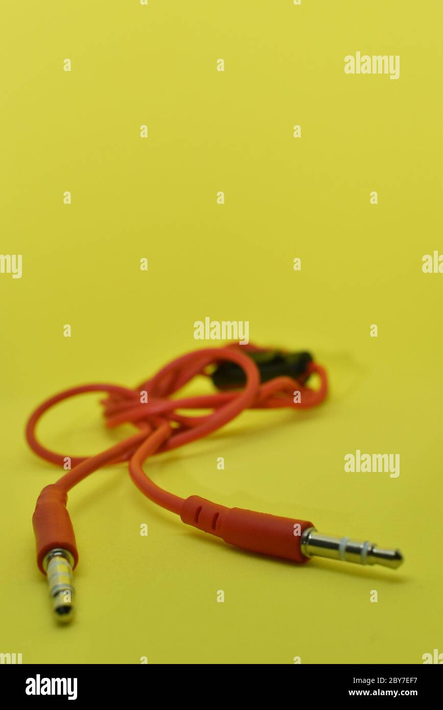 Red color cable in yellow background Stock Photo - Alamy
