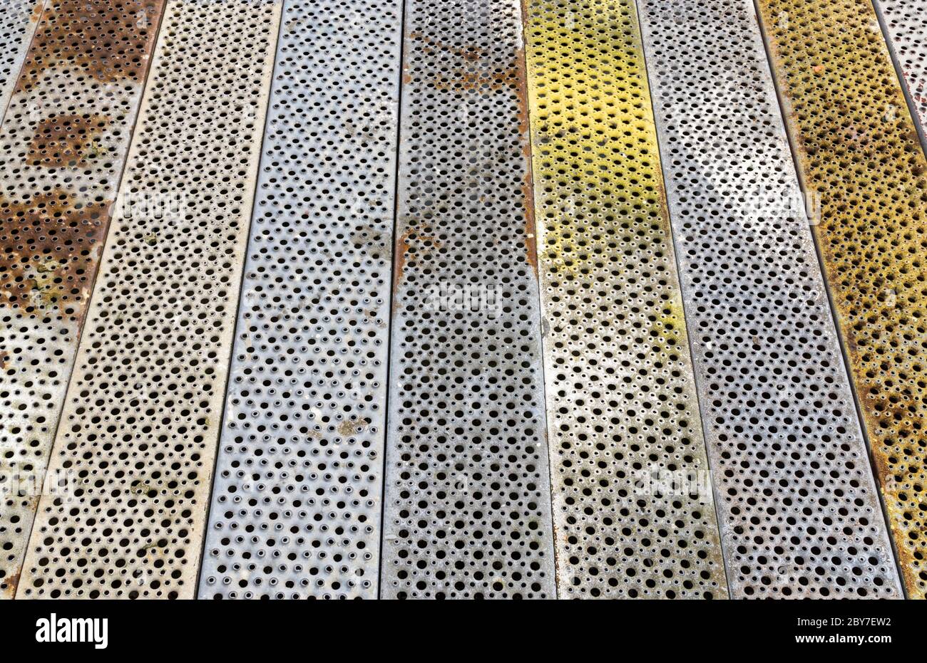 Metal background with perforation of square holes. Gray and colorful ...