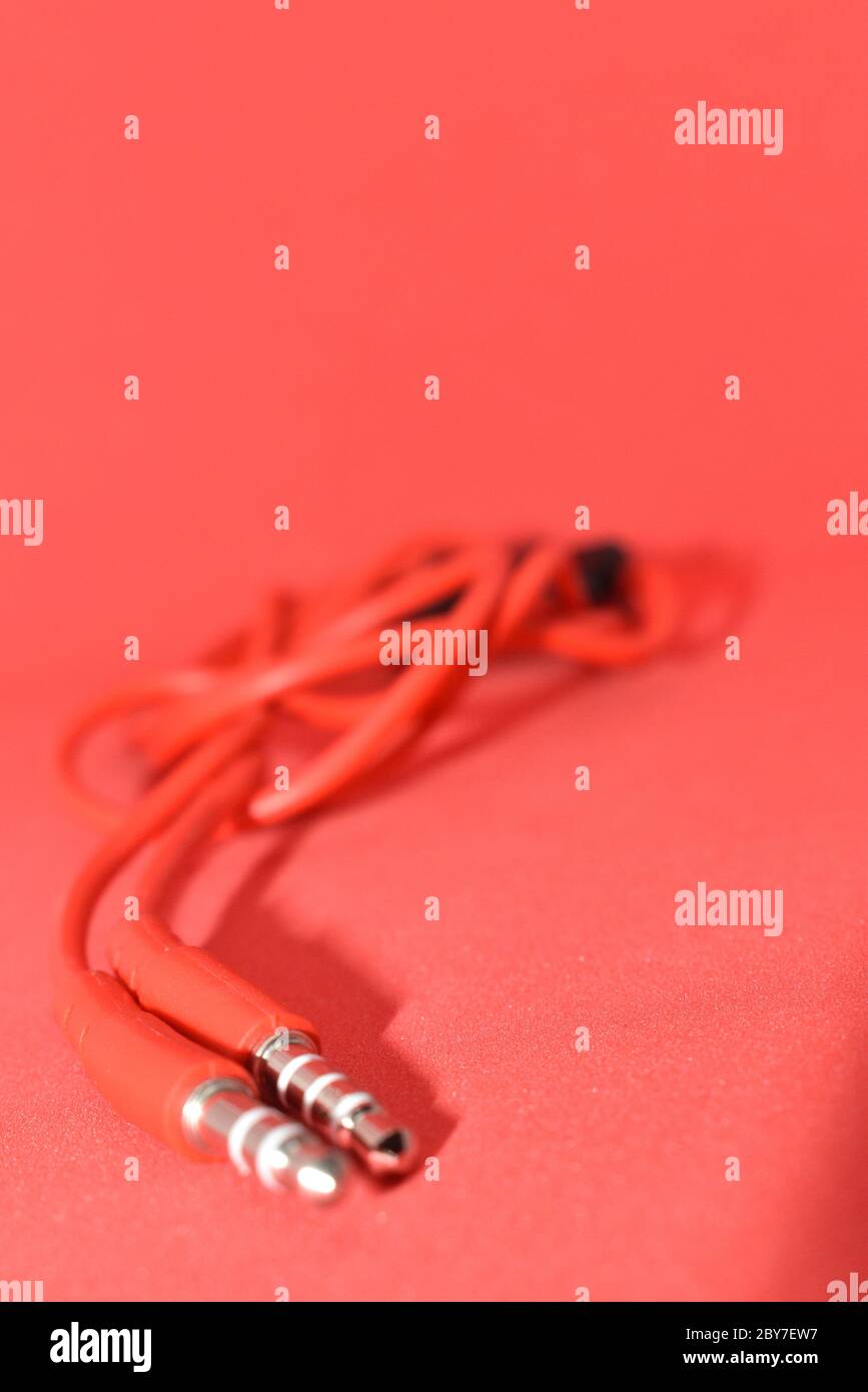 Red color cable isolated in red background Stock Photo - Alamy