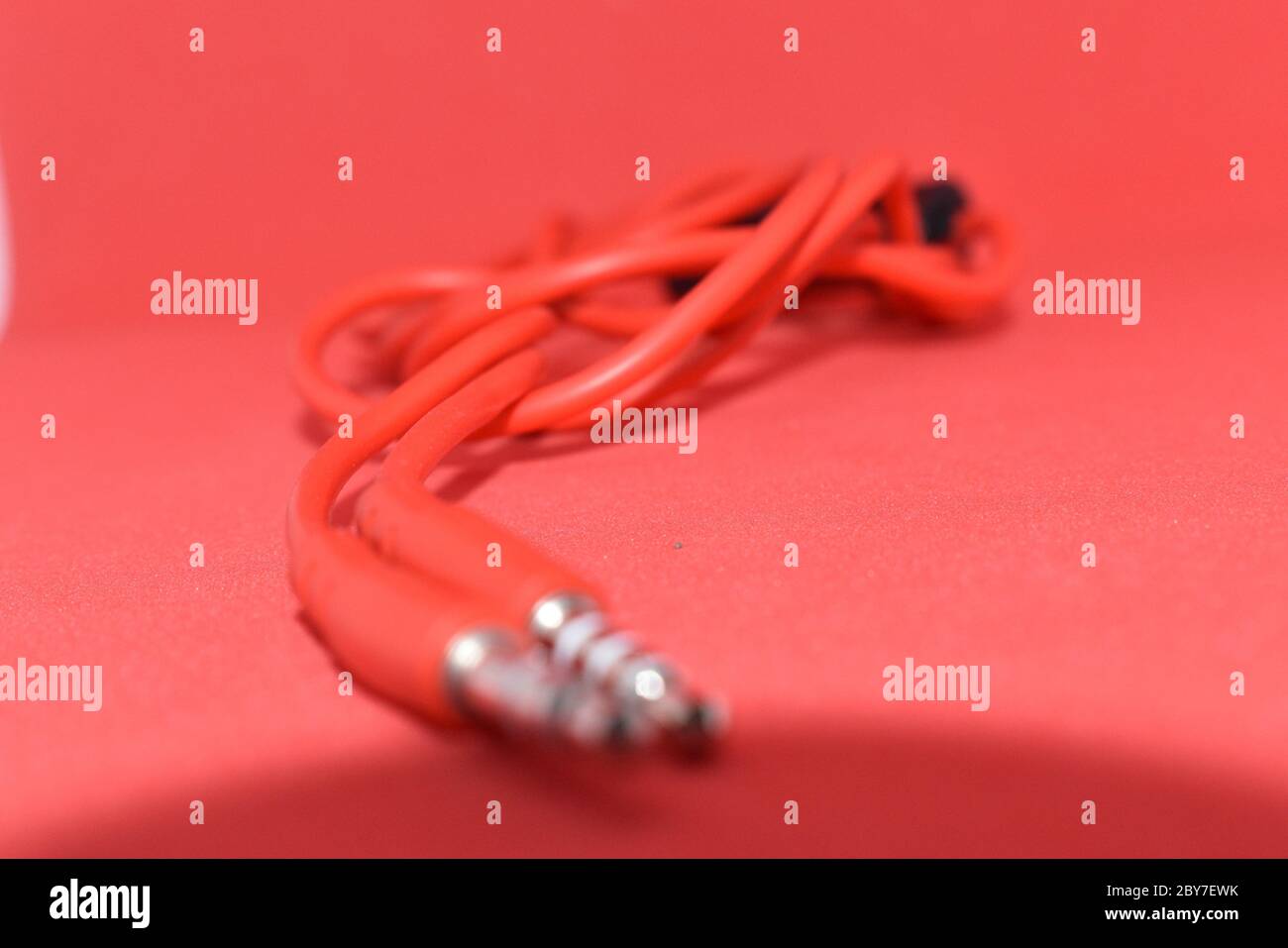 Red color cable isolated in red background Stock Photo - Alamy