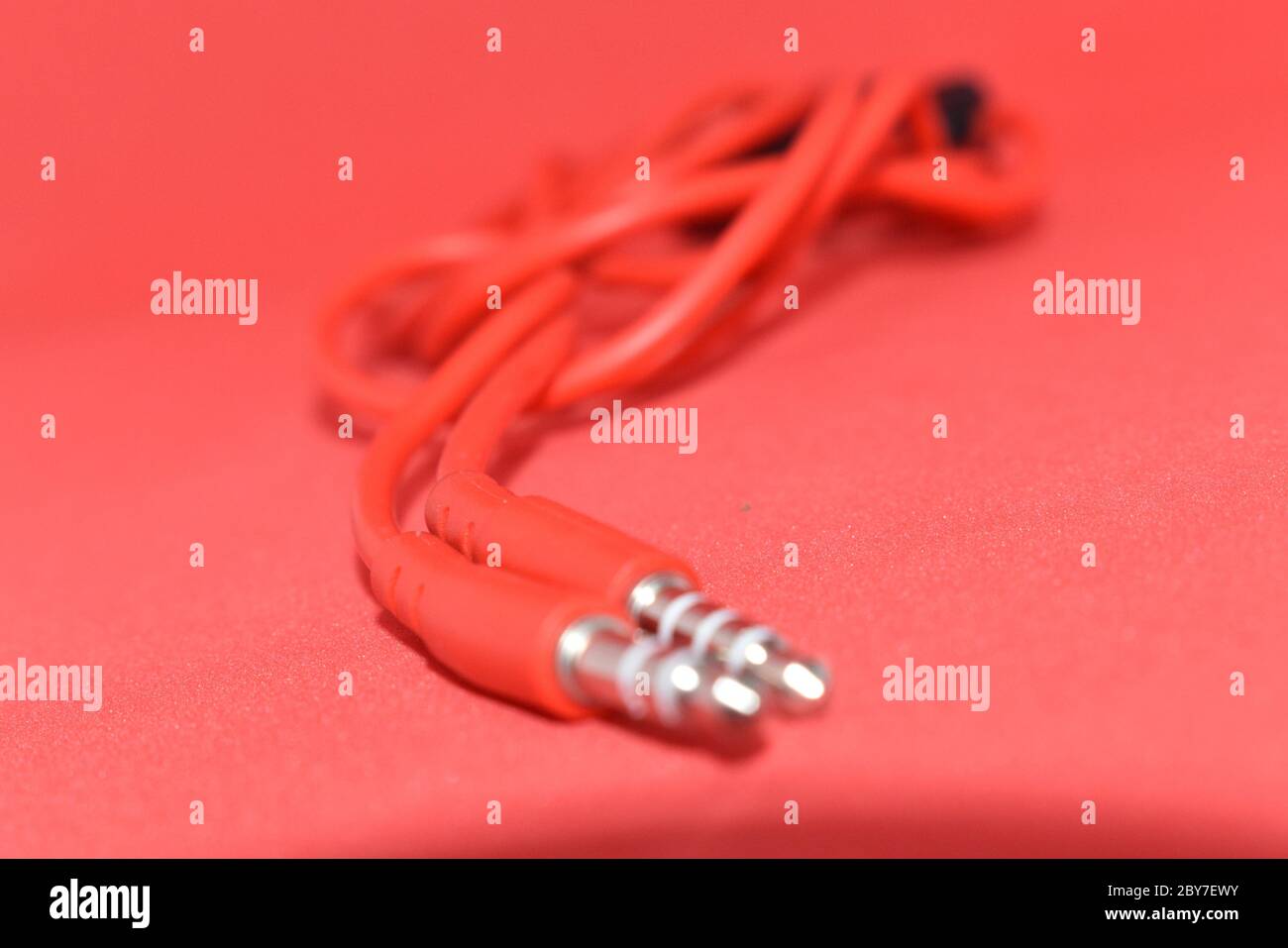 Red color cable isolated in red background Stock Photo - Alamy