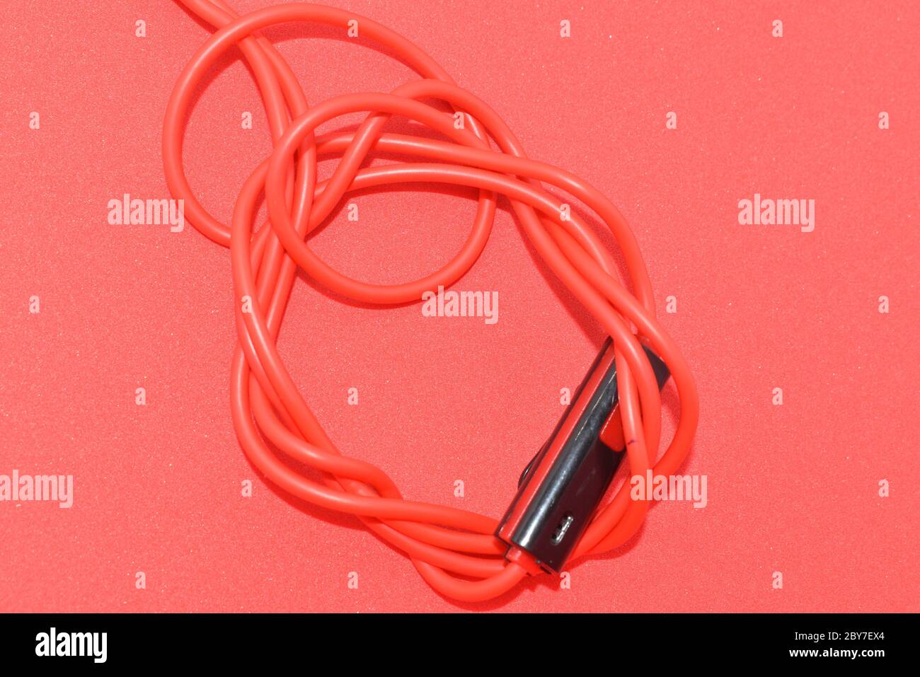 Red color cable isolated in red background Stock Photo - Alamy