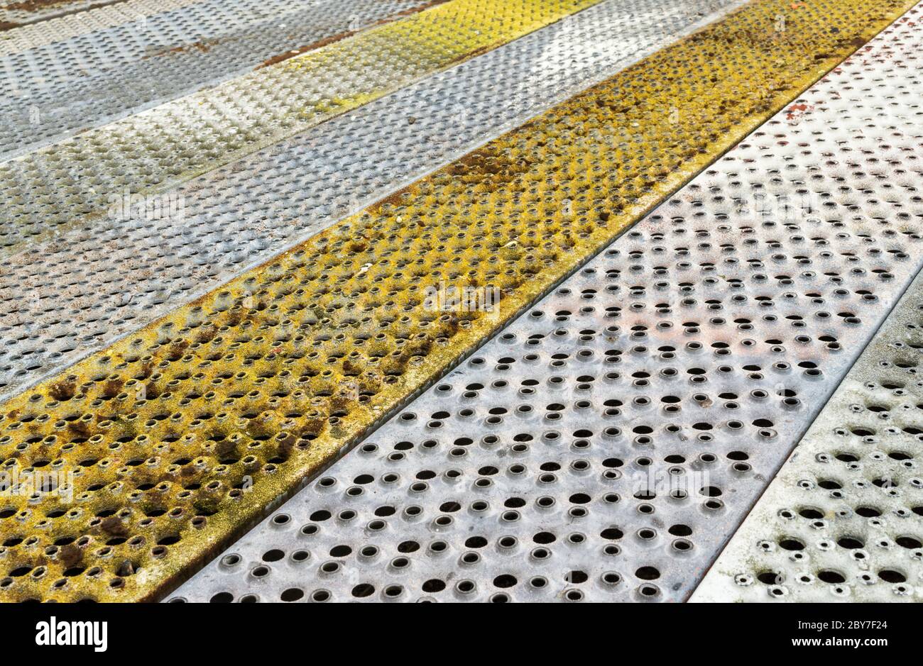 Metal background with perforation of square holes. Gray and colorful ...