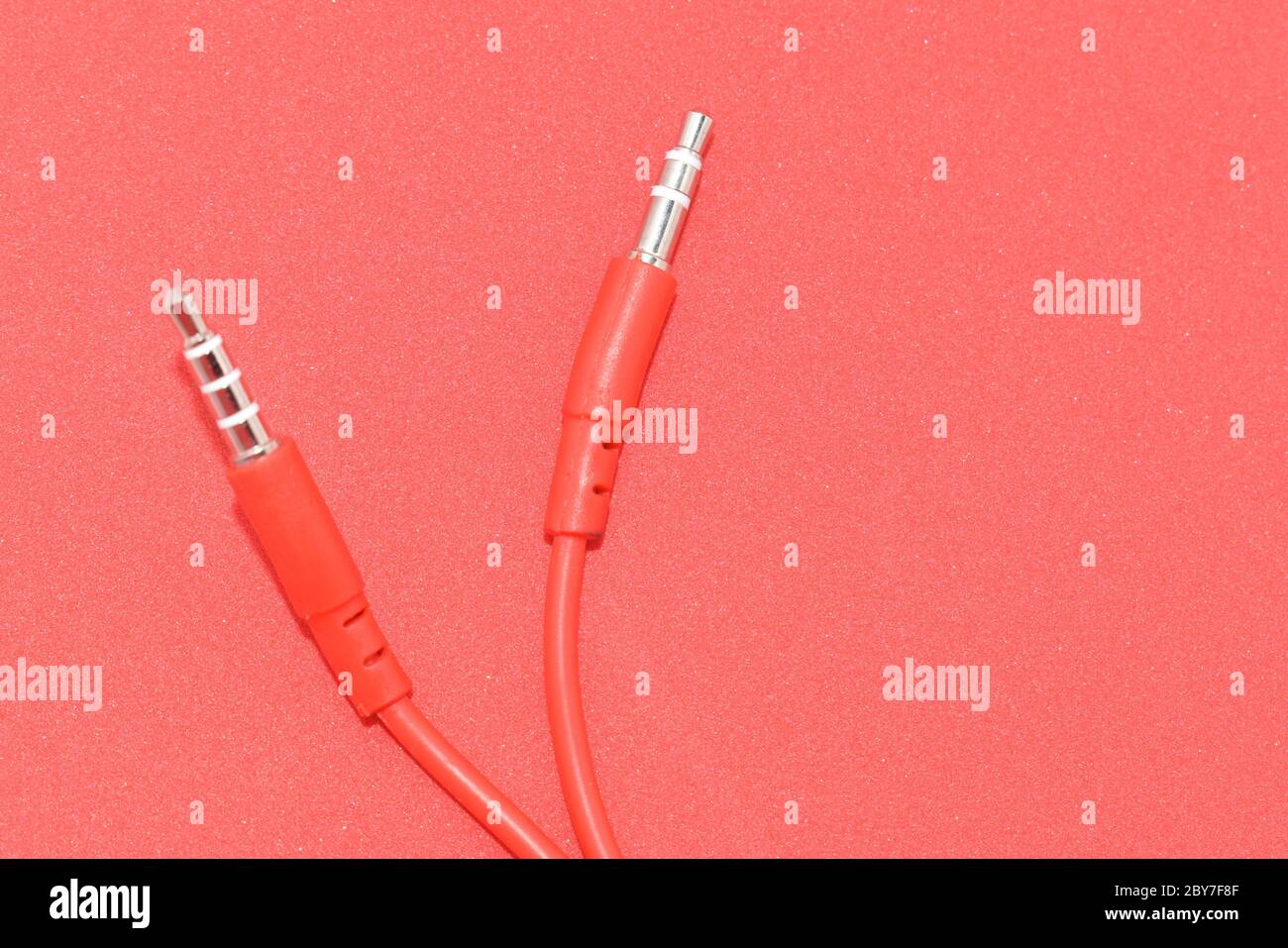 Red color cable isolated in red background Stock Photo - Alamy