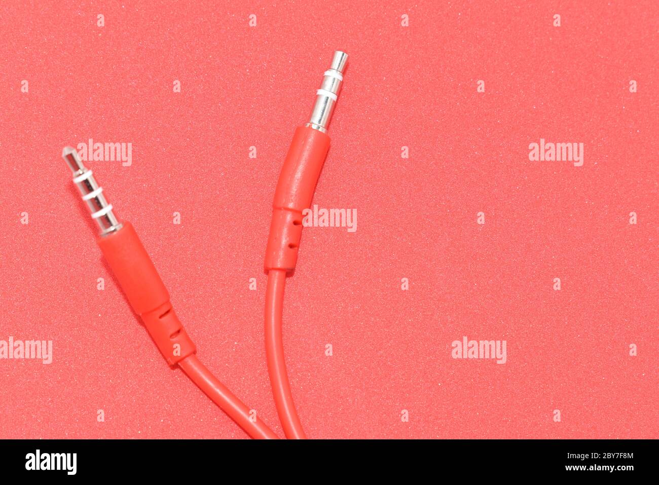 Red color cable isolated in red background Stock Photo - Alamy
