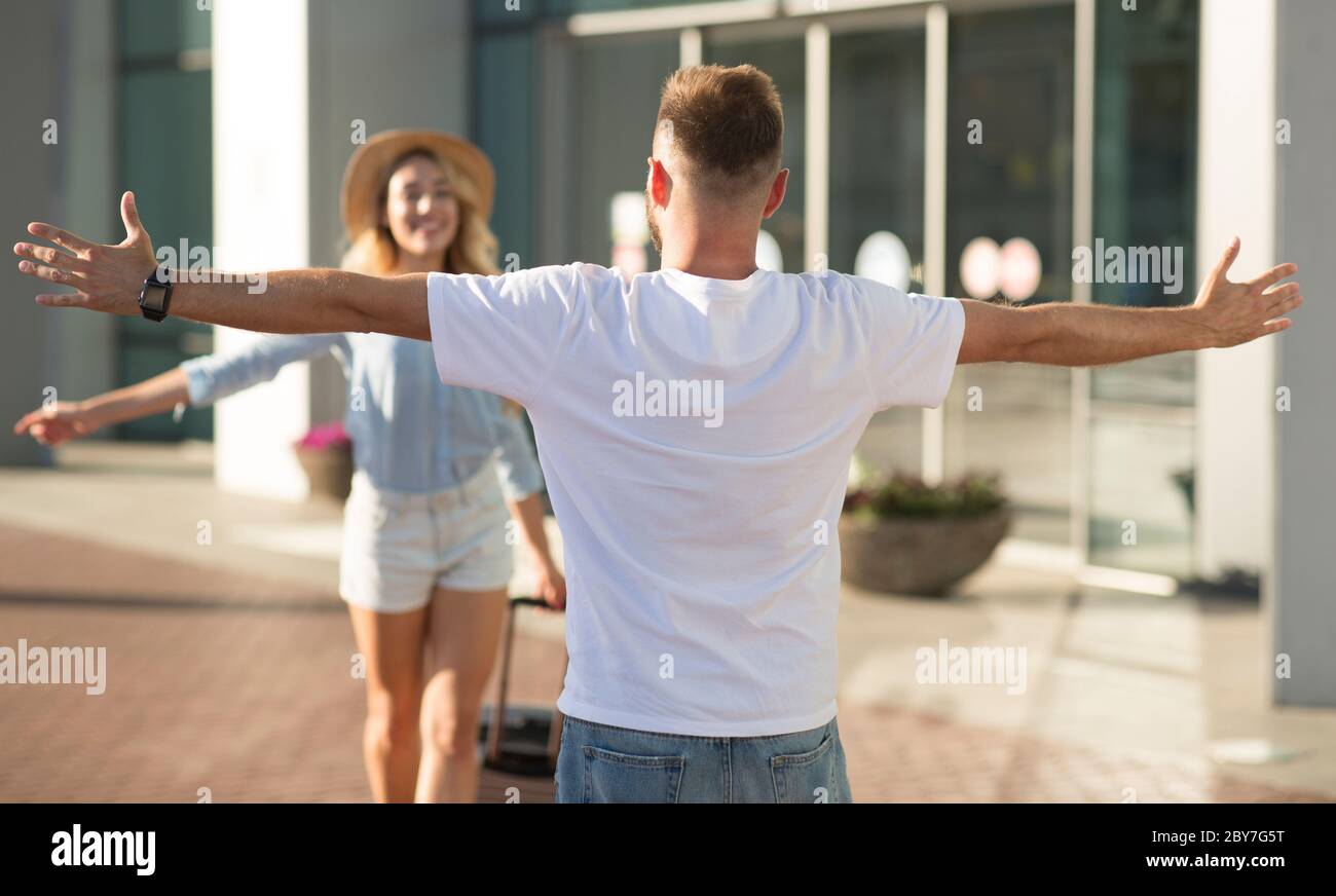 Boyfriend picking up his girlfriend near airport building Stock Photo ...