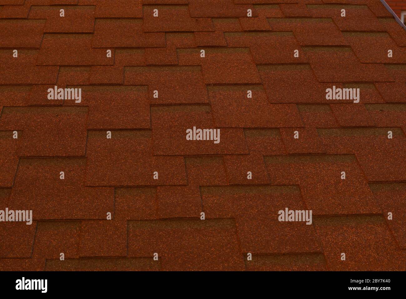 red roof. Metal tile. Part of the house roof as a backdrop for ...