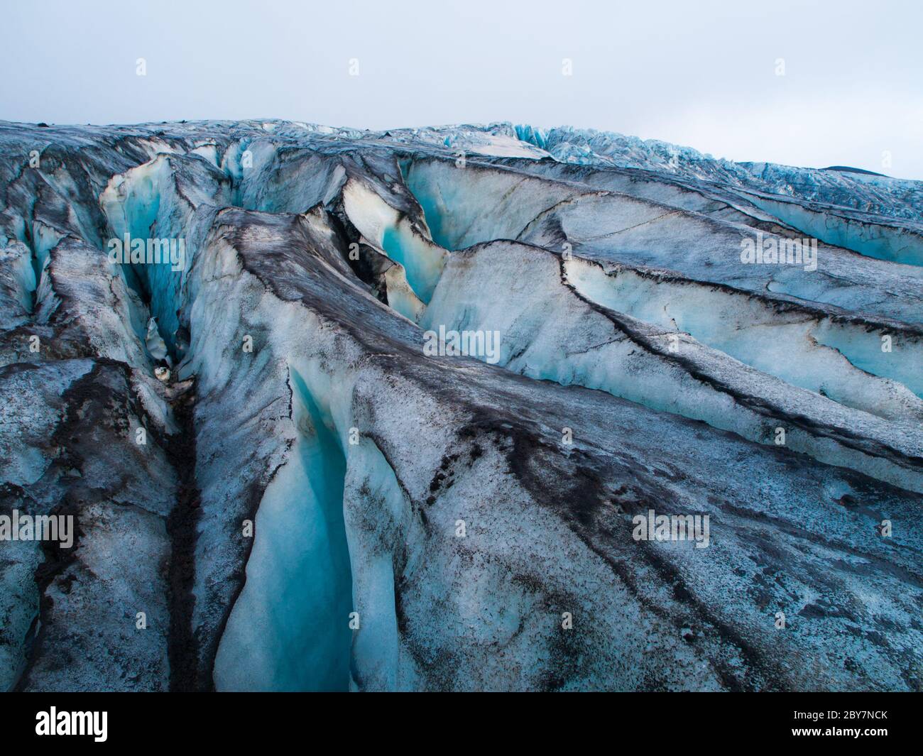 Detailed view of glacier structure with blue vivid colors and dirty ice ...
