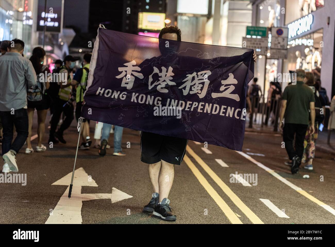 Hong Kong SAR, China. 9th June 2020. A man holds a protest flag ...