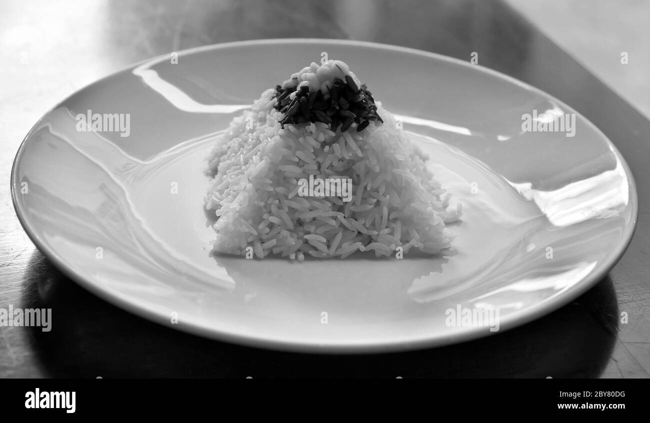 pyramid of rice on a plate in a restaurant with a worn table Stock ...