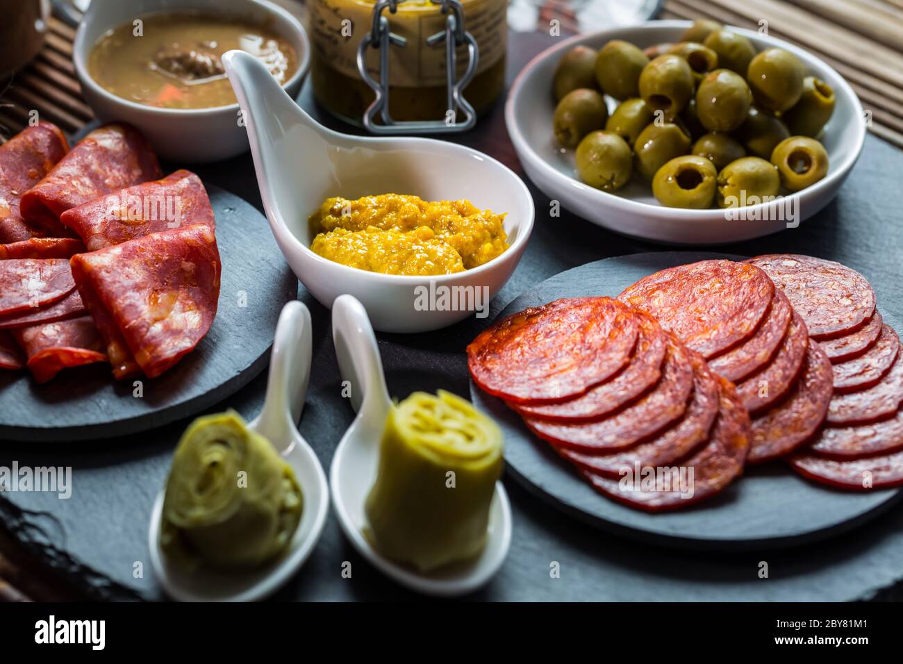 Assortment of tapas and antipasti on black background. Charcuterie ...