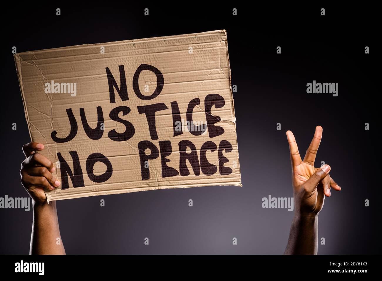 Close up photo of afro american person hand hold banner no peace no ...