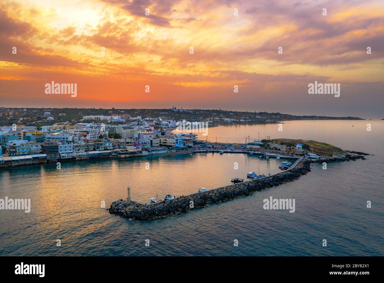 The harbor of the famous resort Chersonissos at sunset, Crete, Greece ...