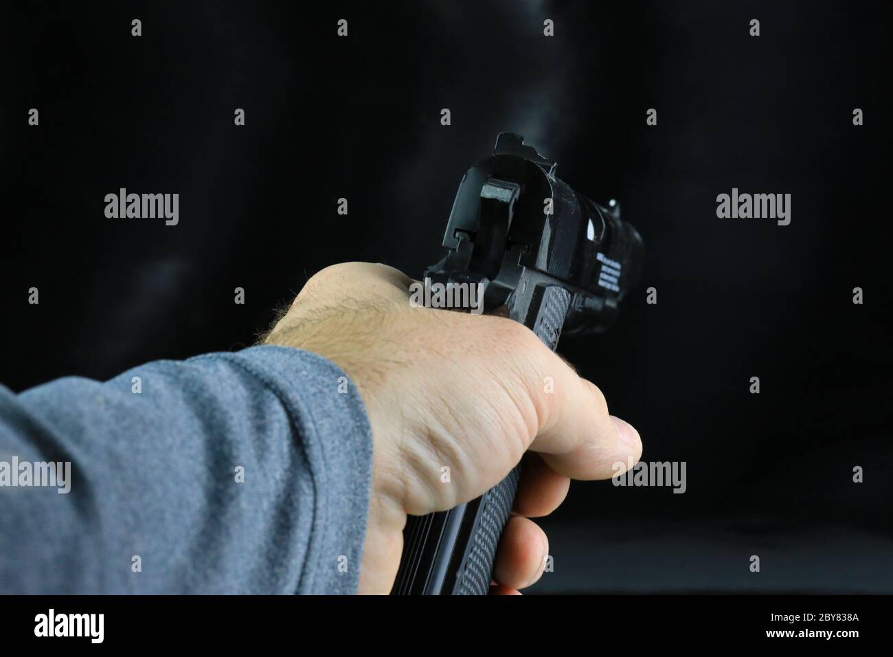 Point of view of a person aiming a hand gun weapon Stock Photo - Alamy