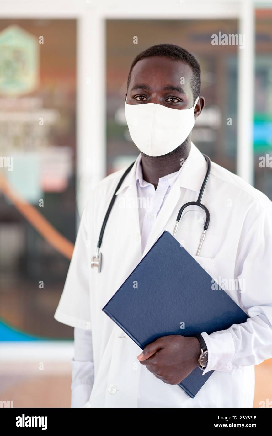 African doctor wear face mask and stethoscope with professional and ...