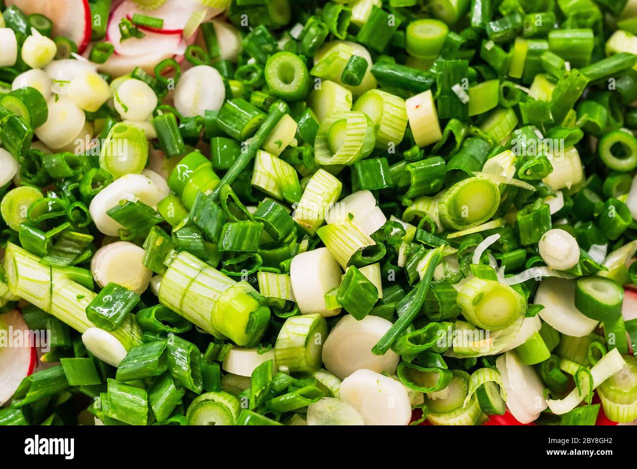 Salad with sliced radish and onion background texture closeup Stock ...