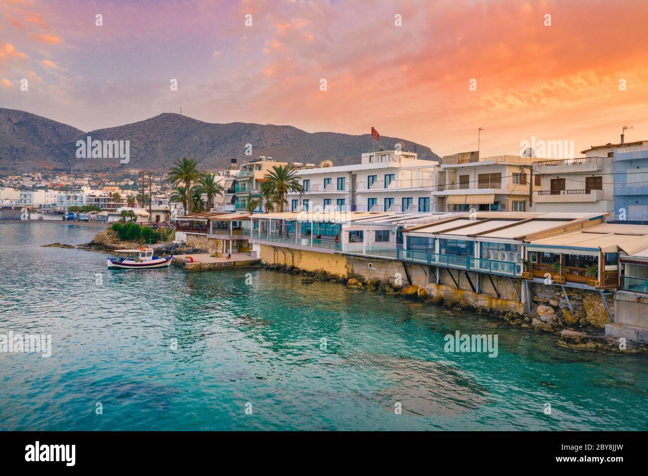 The harbor of the famous resort Chersonissos at sunset, Crete, Greece ...