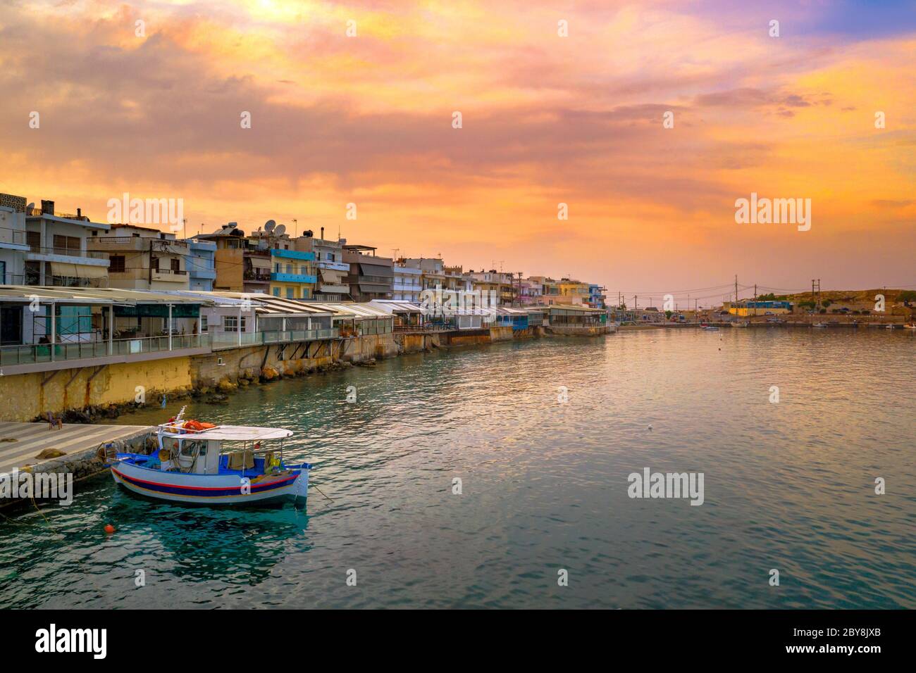 The harbor of the famous resort Chersonissos at sunset, Crete, Greece ...