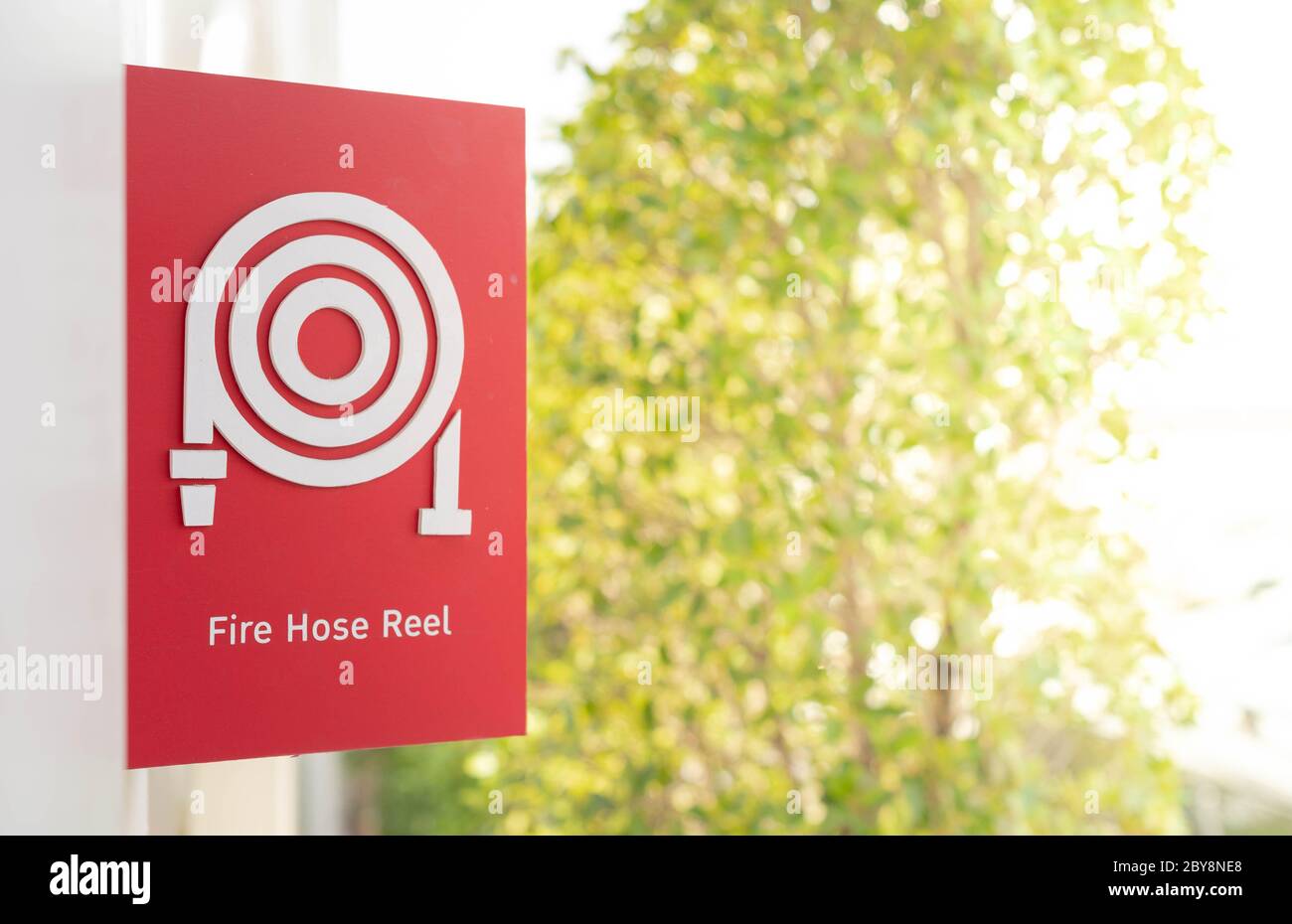 Red fire alarm sign on the white wall for safety first and sign for ...