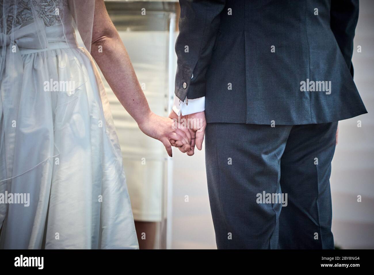 Couple holding hands during a marriage ceremony Stock Photo - Alamy