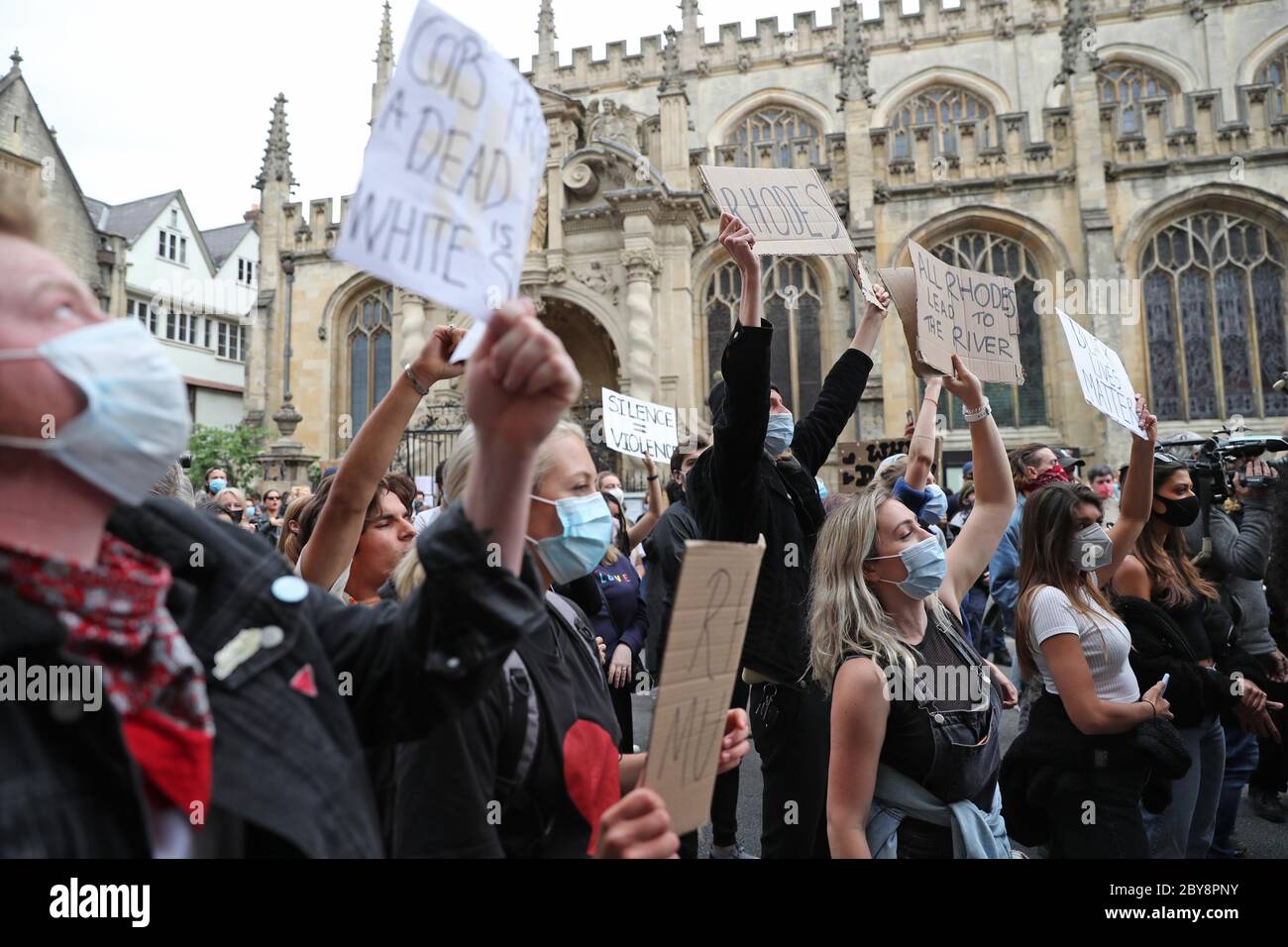 People during a protest calling for the removal of the statue of 19th ...