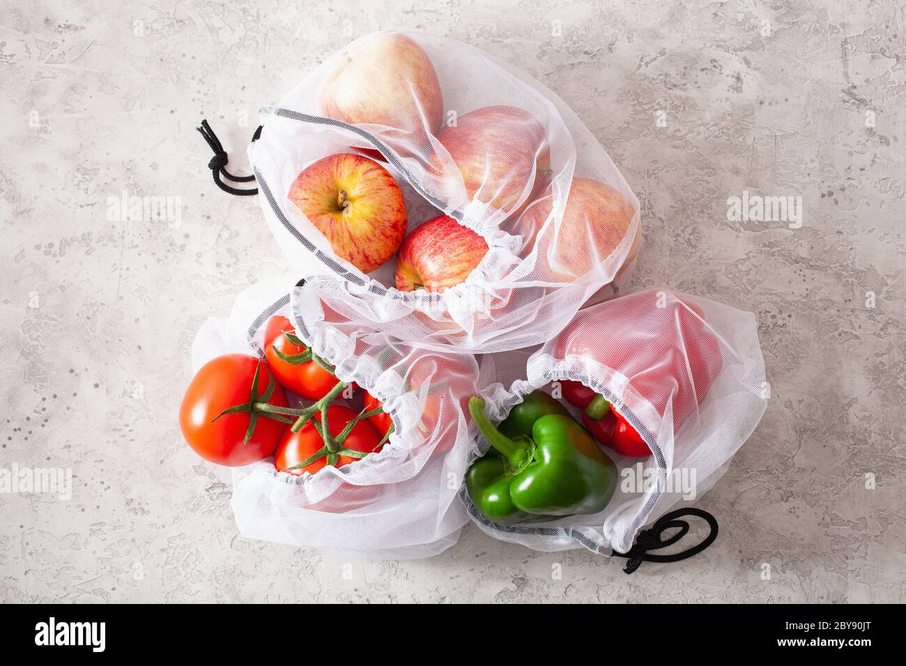 apples tomatoes bell peppers vegetables in reusable mesh nylon bag ...
