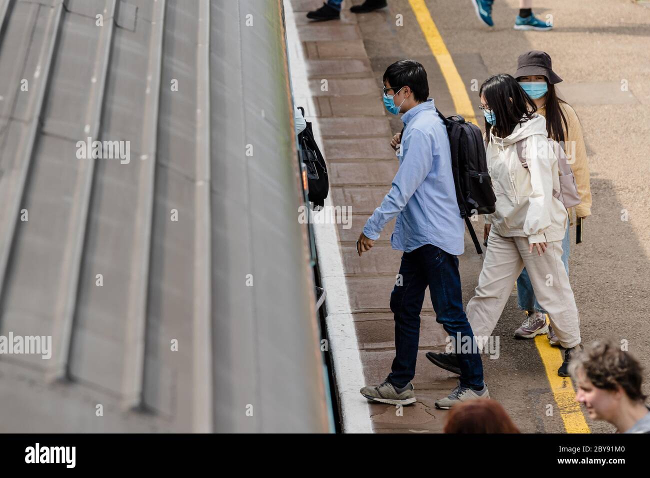 TAFFS WELL, WALES - 09 JUNE 2020 - Rail passengers wearing face masks ...