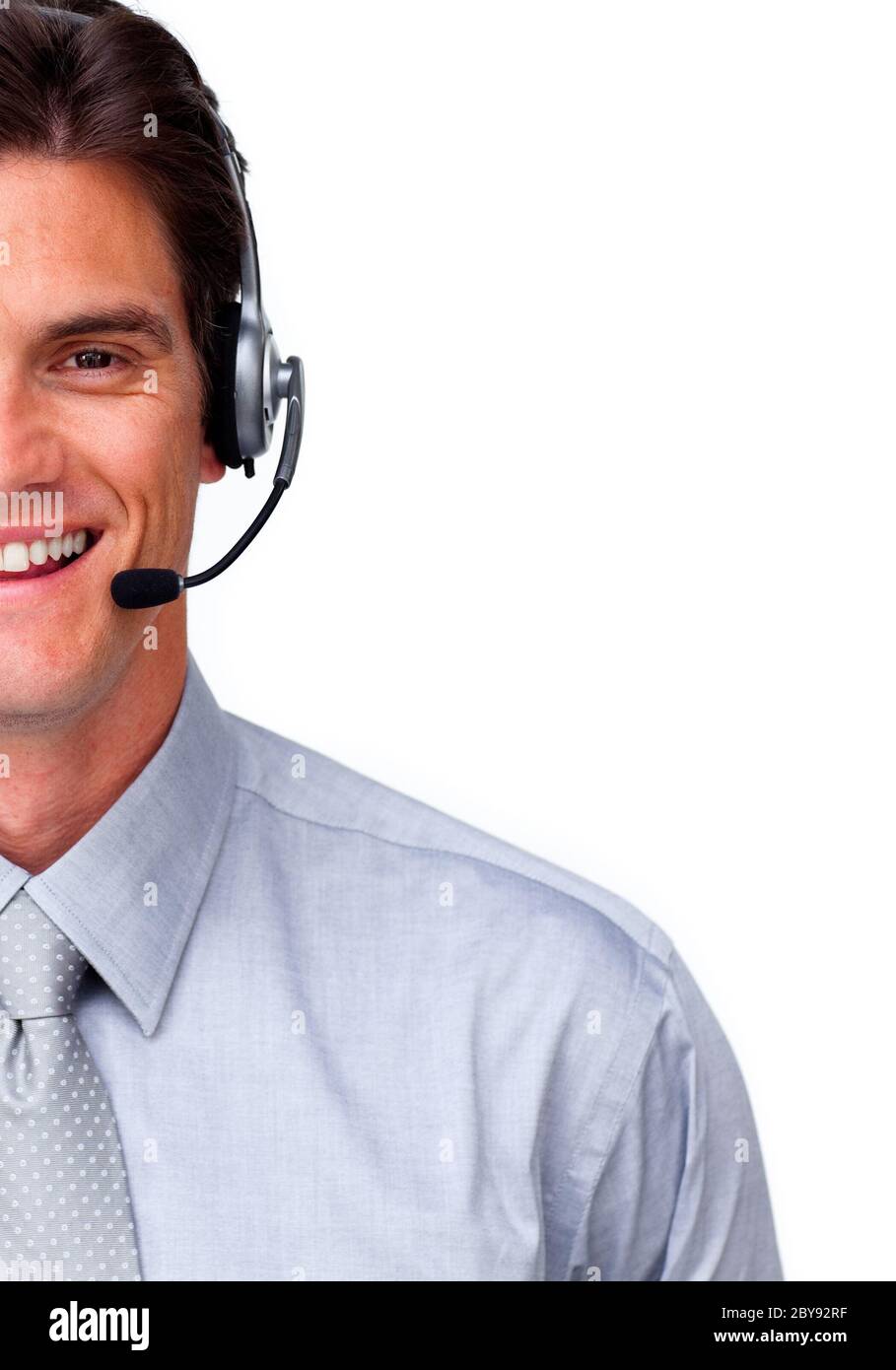 Smiling customer service representative with headset on against a white ...