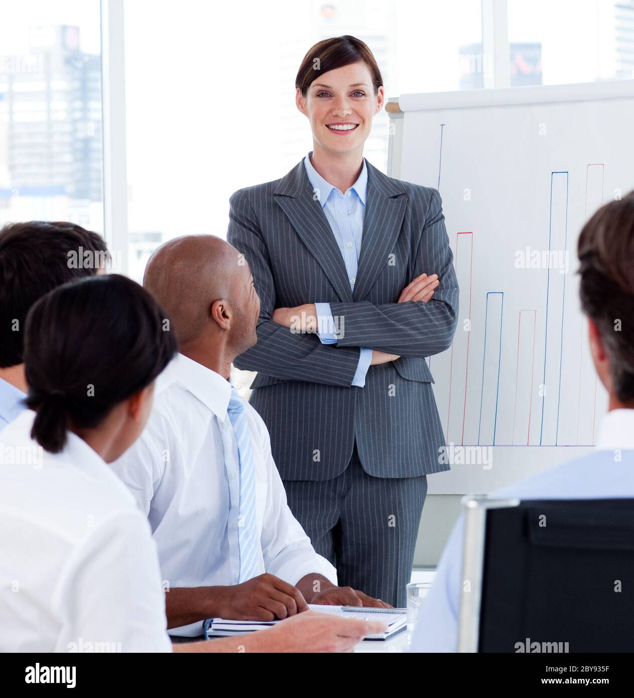 Female executive smiling at the camera Stock Photo - Alamy
