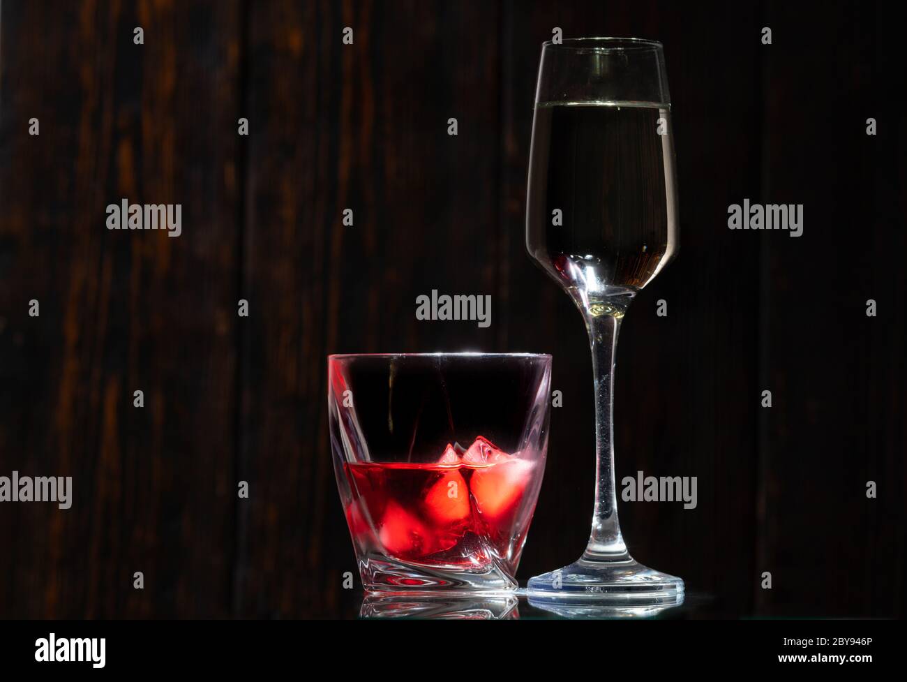 Glasses of brandy on ice and white wine in an elegant wineglass on a ...