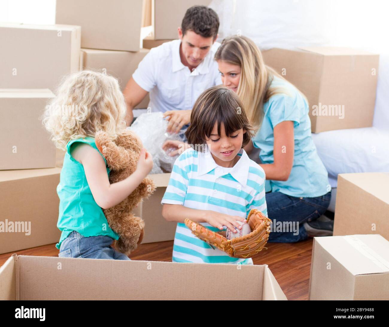 Caucasian family packing boxes Stock Photo - Alamy