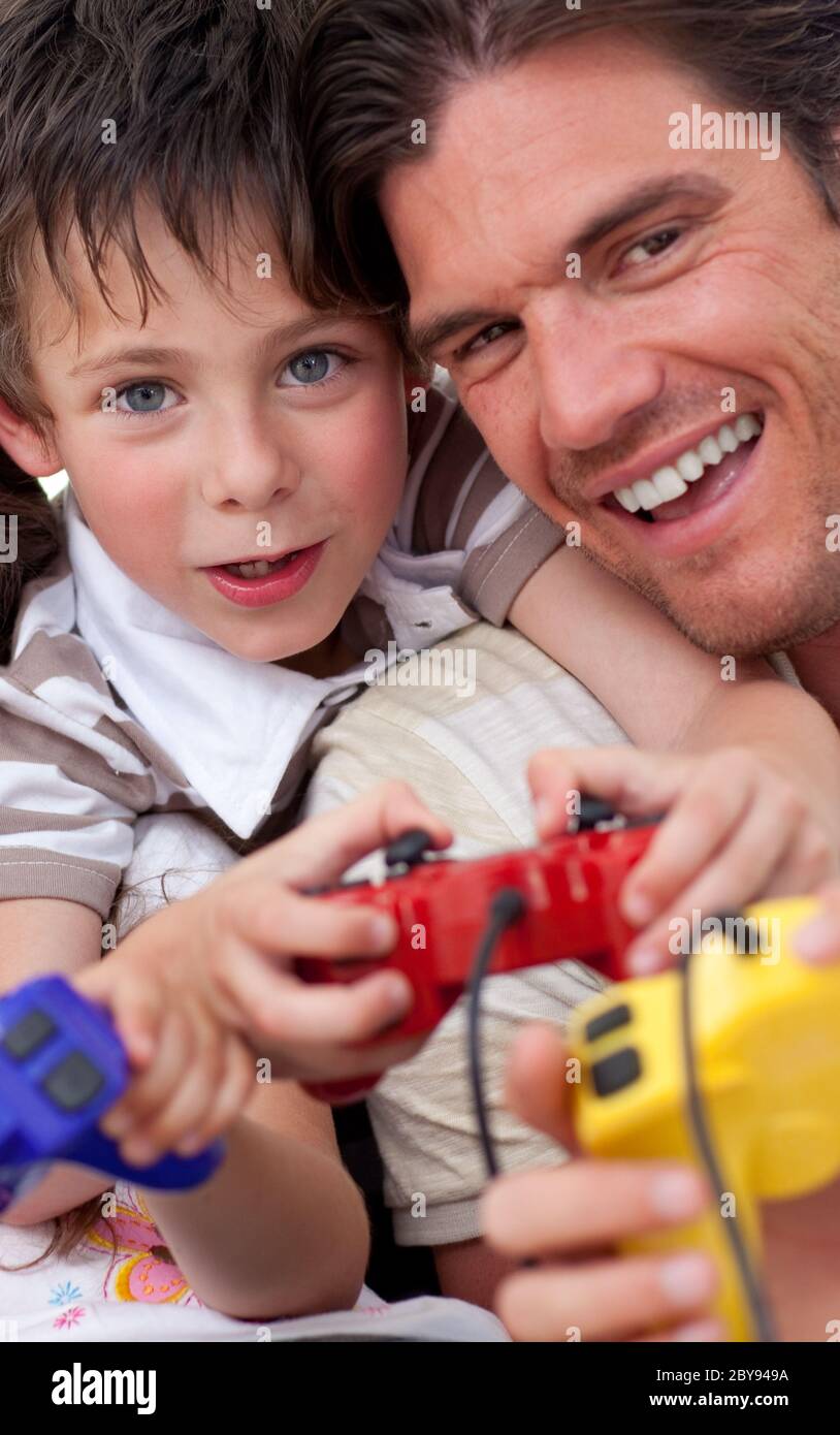 Portrait of a happy father and his son playing video games Stock Photo ...