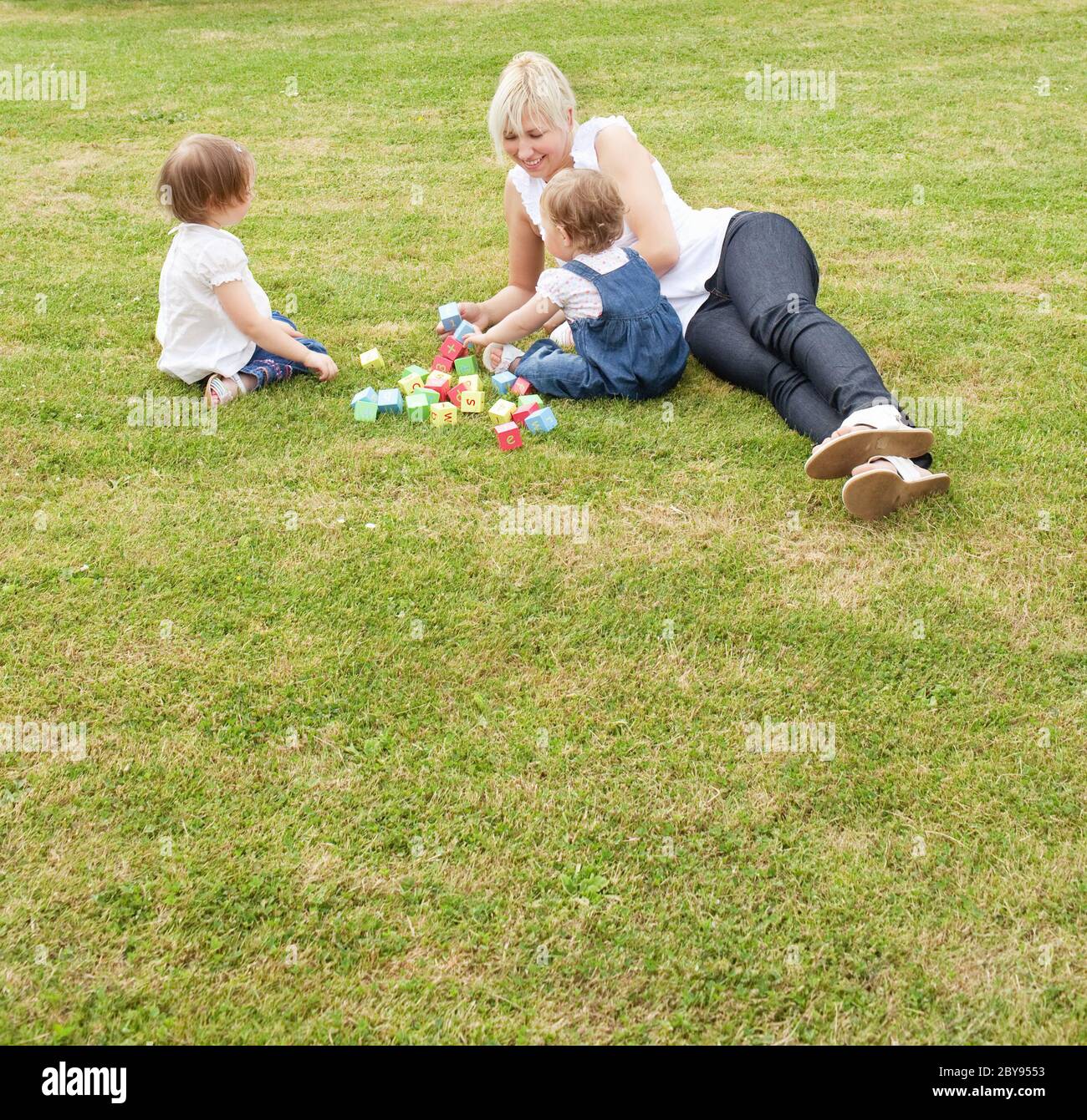 Smiling mother having fun with her kids Stock Photo - Alamy