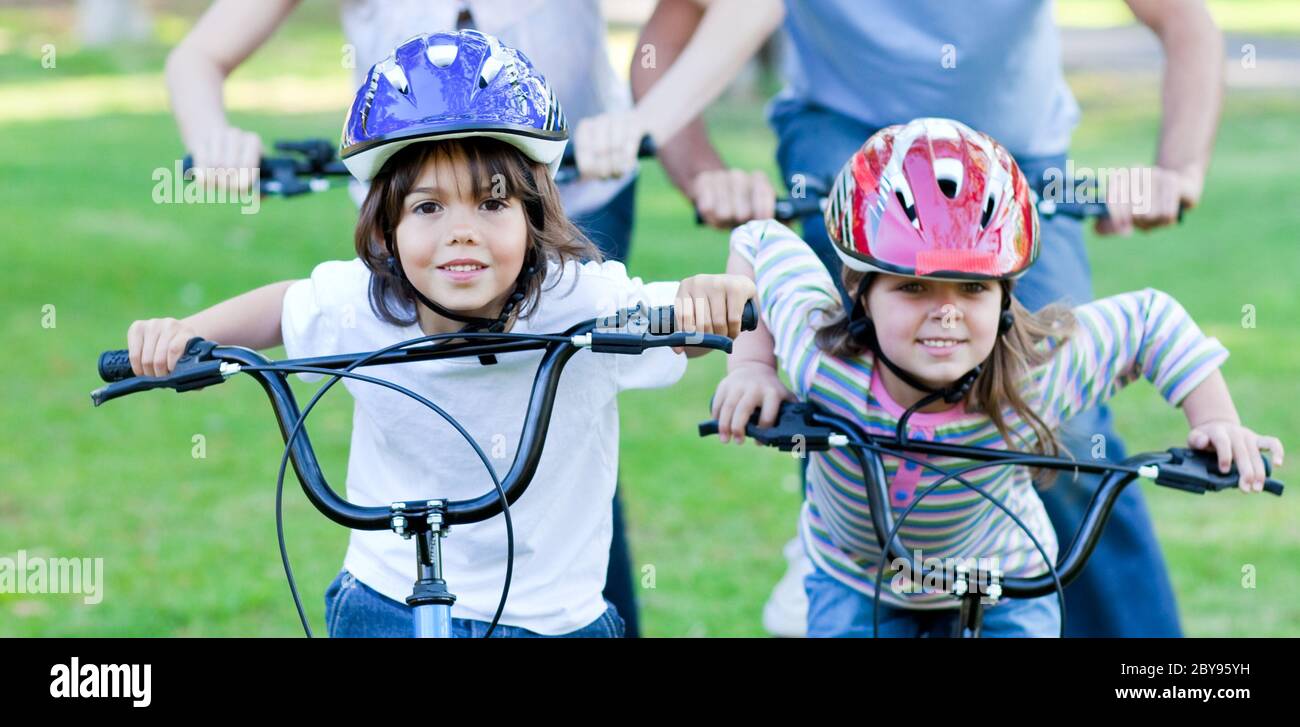 Jolly children riding a bike Stock Photo - Alamy