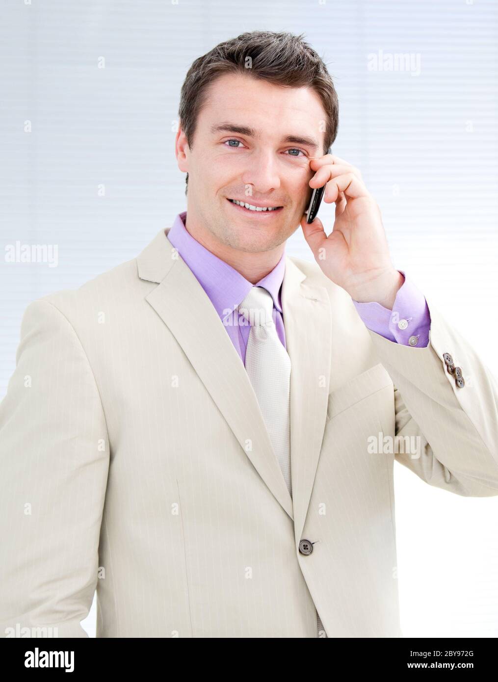 Smiling businessman talking on phone Stock Photo - Alamy