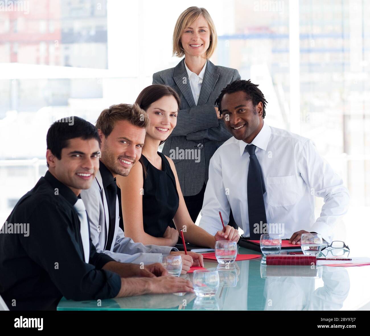 Business team smiling at the camera in office Stock Photo - Alamy