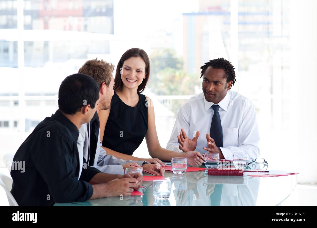 Business team interacting to each other in office Stock Photo - Alamy