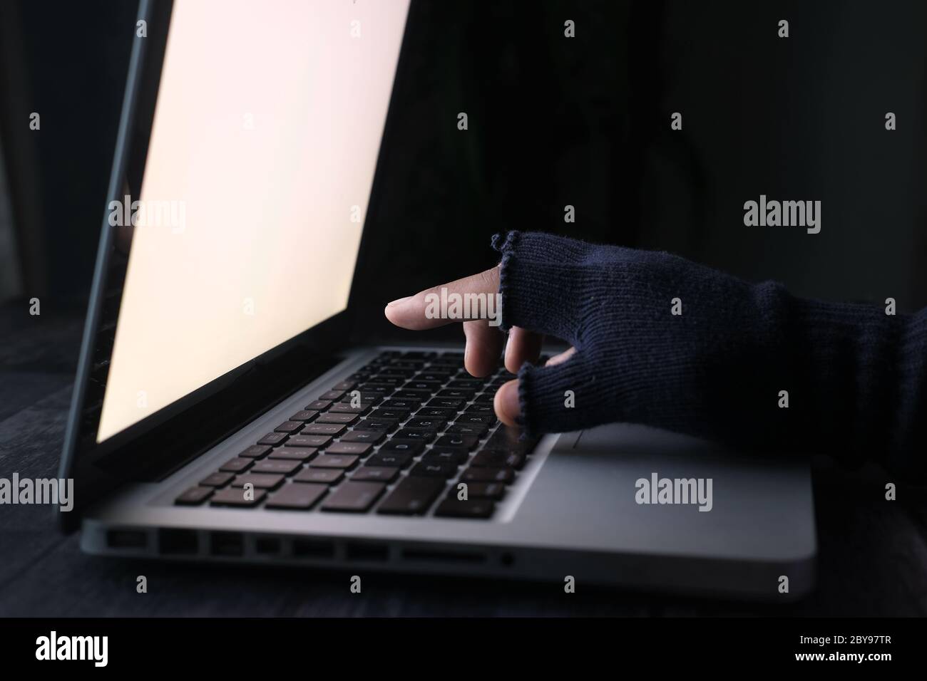 Close up of hacker hand stealing data from laptop Stock Photo - Alamy