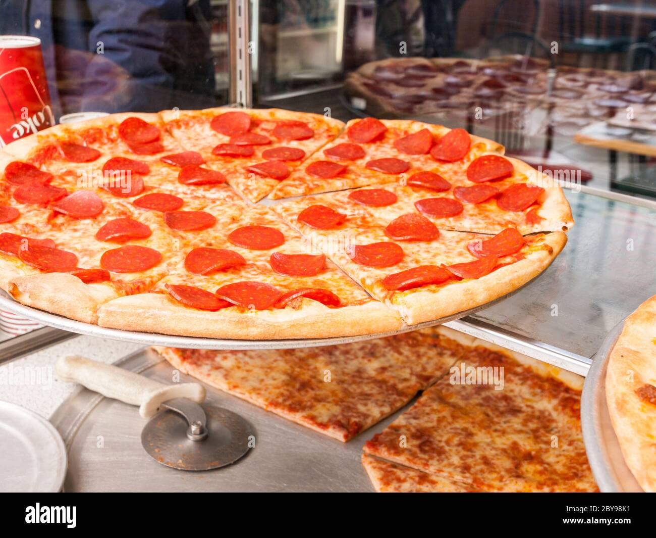 Pizza and pizza making Pizza on display at counter Stock Photo - Alamy