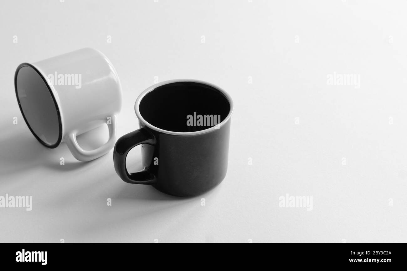 Side view of blank black coffee cup and white coffee cup minimalist mug ...