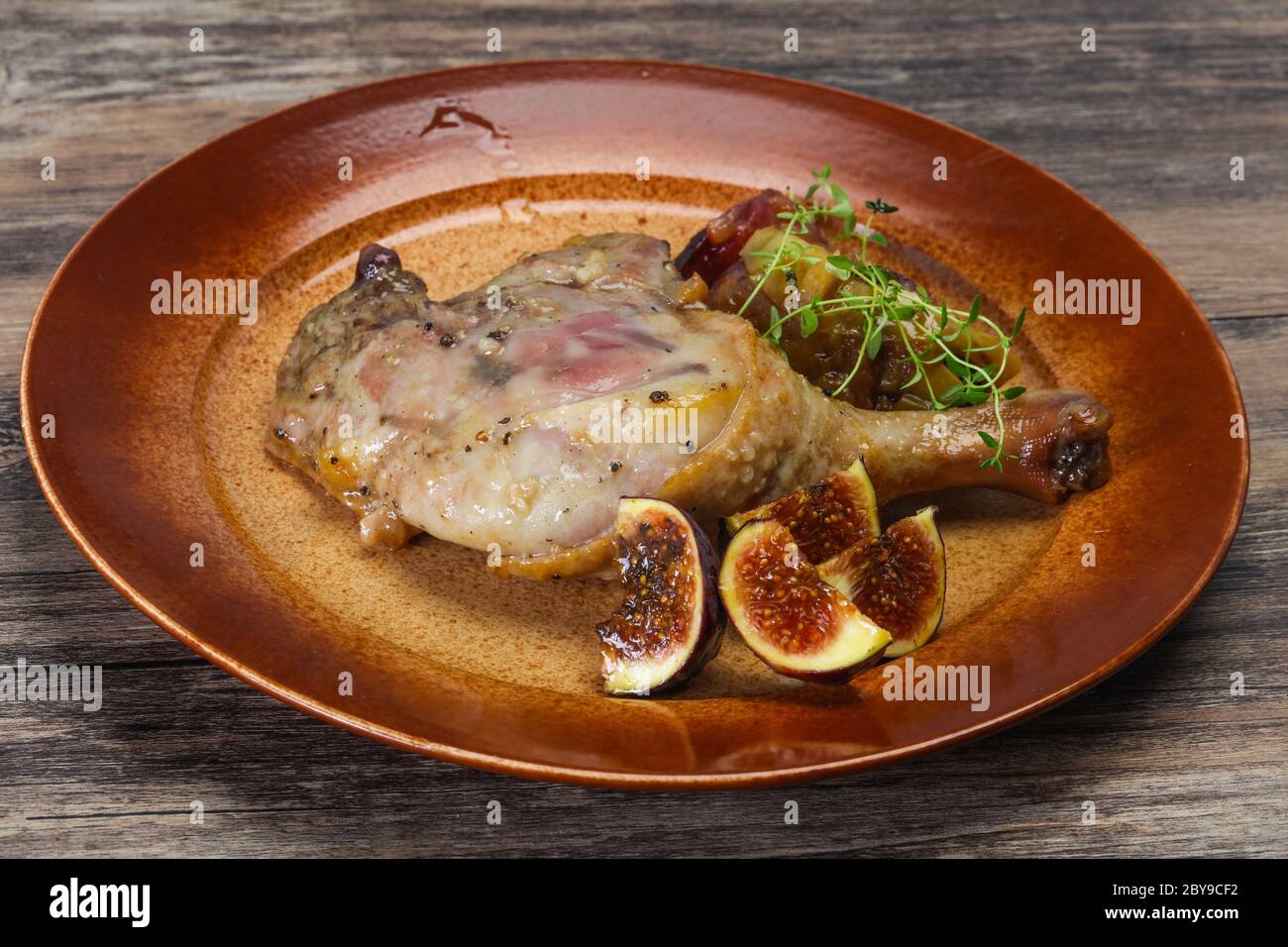Roasted. duck. leg with plum, fig and apple Stock Photo - Alamy