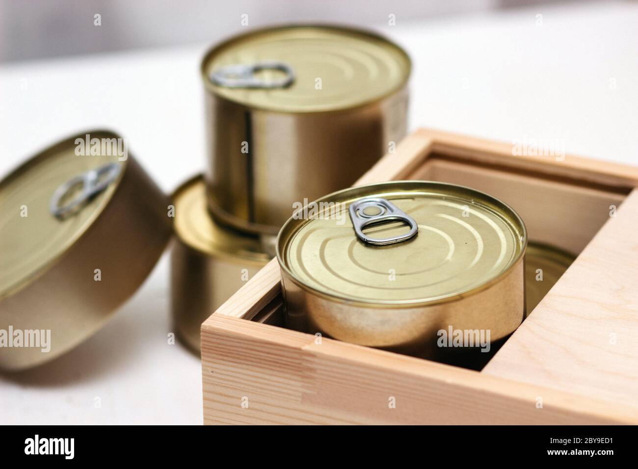 Tin cans in a box. A variety of canned food in full tin cans. Real ...