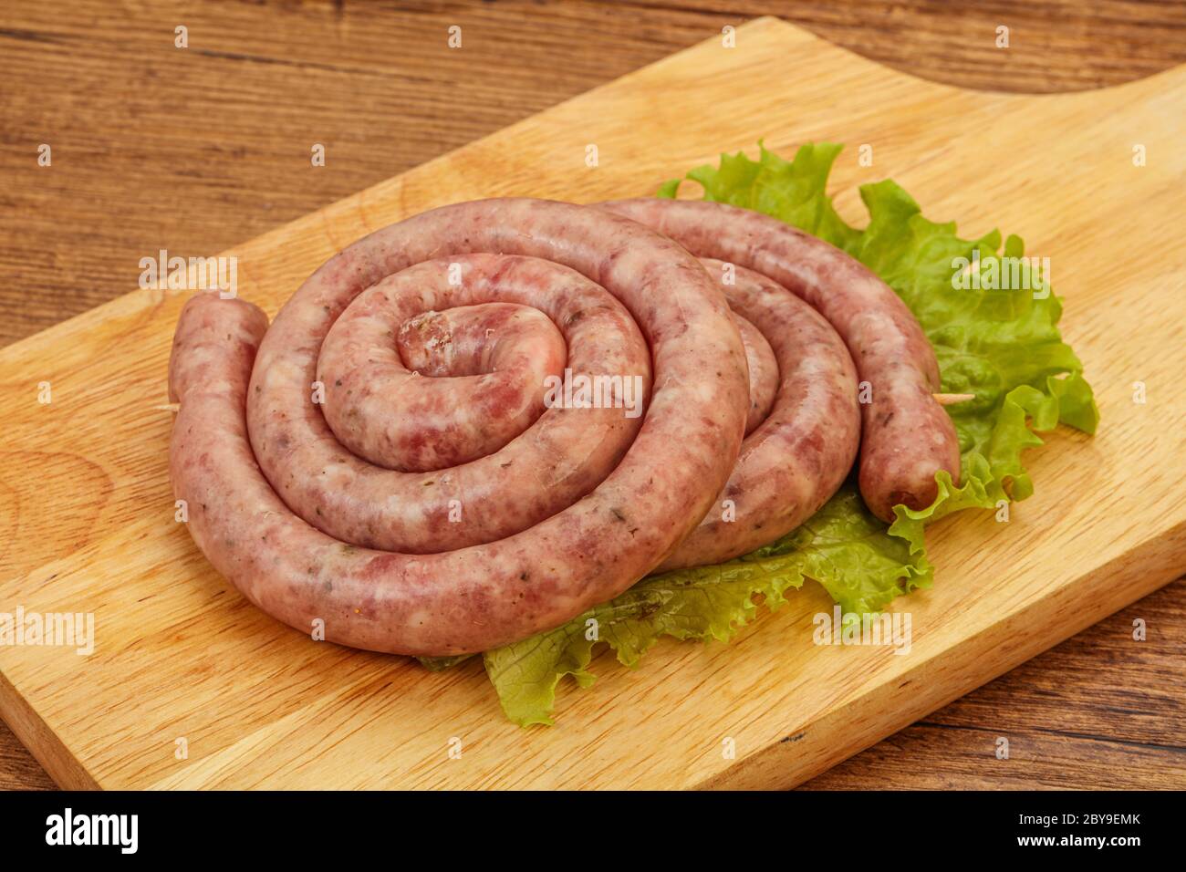 Raw pork sausage ring for grill Stock Photo - Alamy