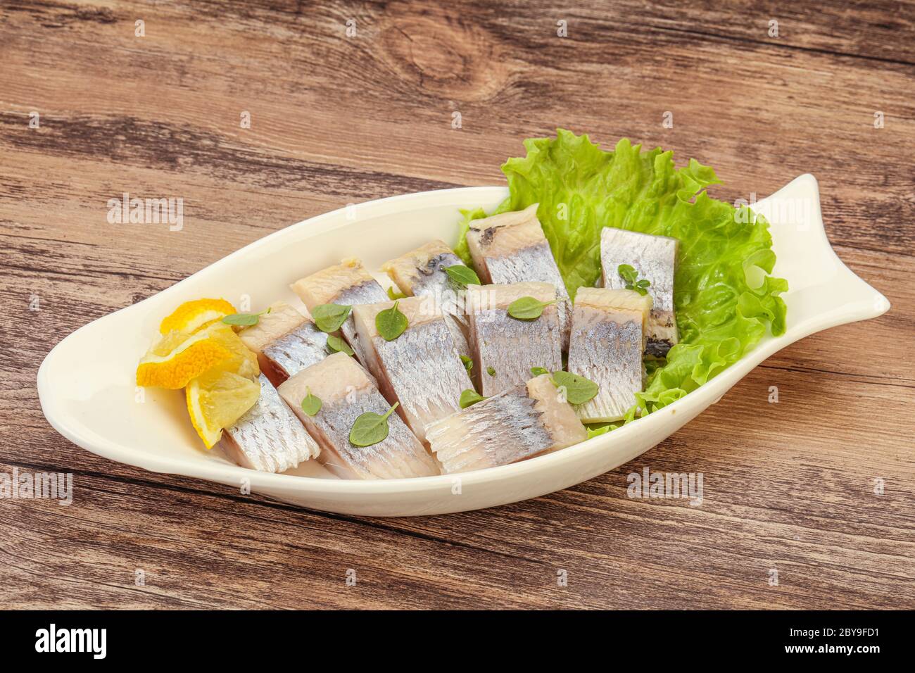 Marinated Herring fillet with sliced lemon Stock Photo - Alamy