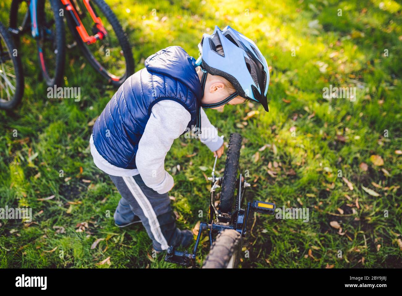 Cyclist boy Bike repair. little boy fixing his bike. Children mechanics ...