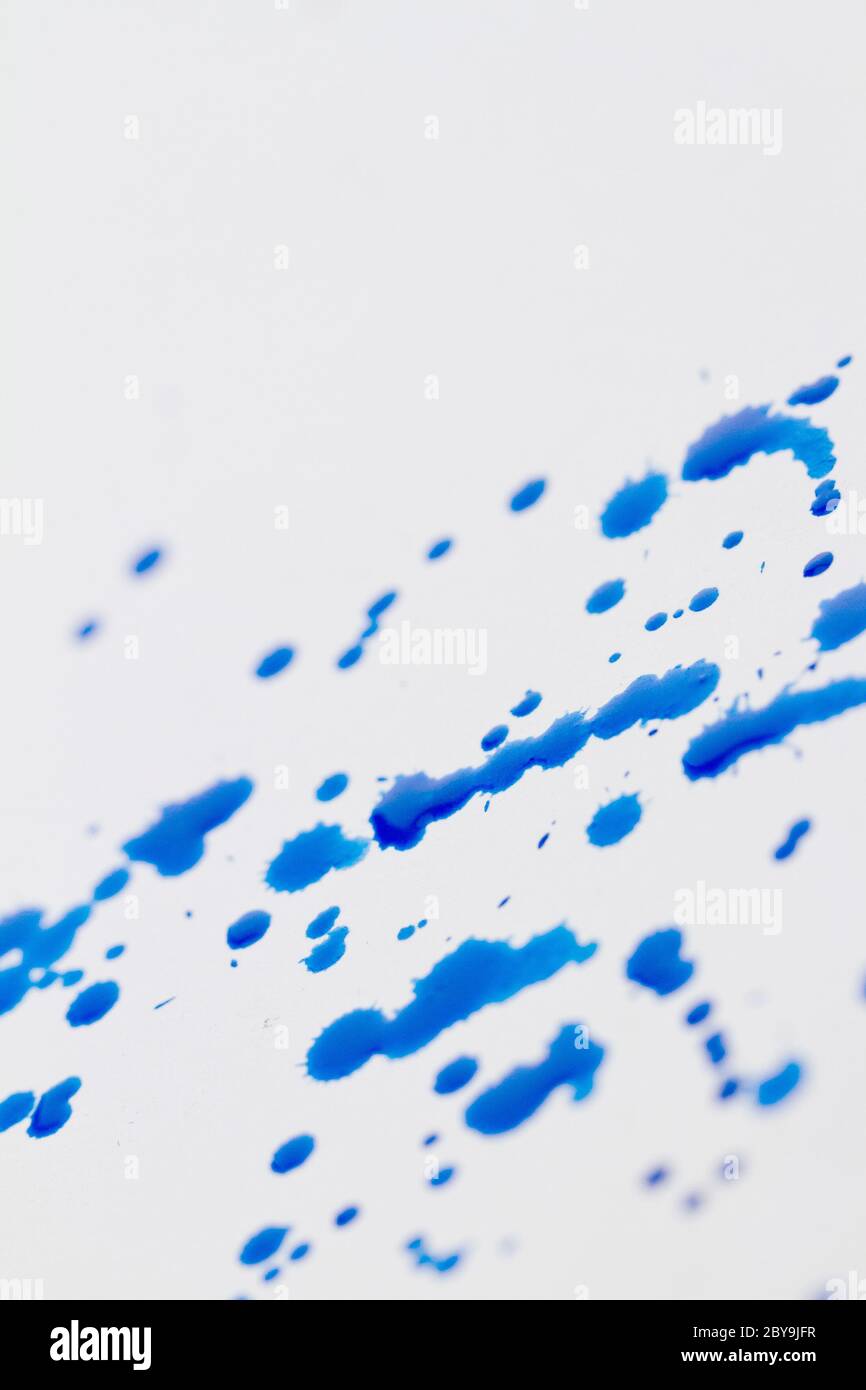 Blue splatter on white background Stock Photo - Alamy