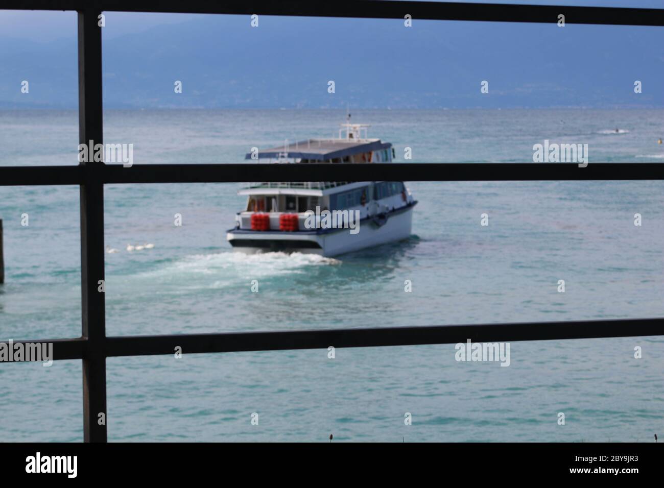 a passengers vessel on travel behind a iron frame Stock Photo - Alamy